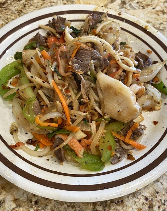 A plate that tells the story of culinary wanderlust—noodles, meat, and vegetables dancing together in perfect harmony. This is what world peace looks like on a plate.