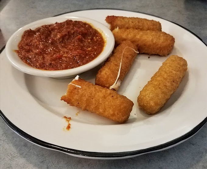 These aren't just mozzarella sticks—they're crunchy vessels of molten cheese joy, waiting to be dunked in that vibrant marinara sea.