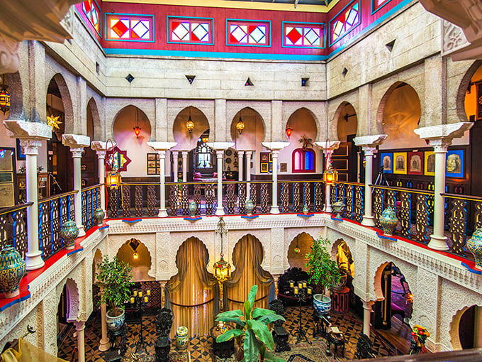 The Court of Lions reveals itself in all its glory—a two-story atrium where horseshoe arches, intricate balustrades, and colorful tiles create a space that defies Florida's zip code.