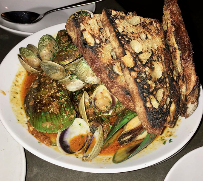 Not your average seafood dish—these mussels and clams swim in a broth so good you'll contemplate drinking it straight from the bowl.