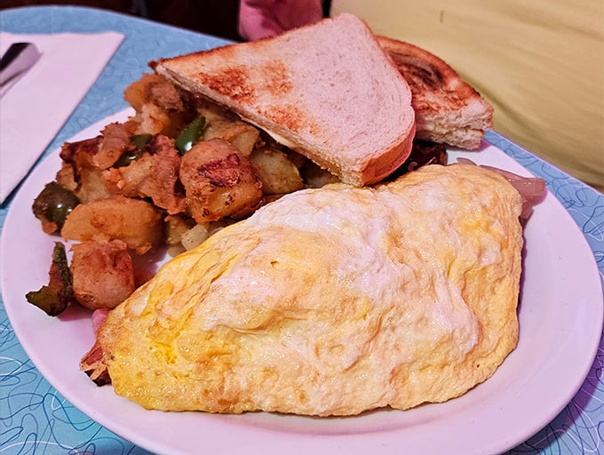 The omelet of champions! Perfectly fluffy eggs wrapped around savory fillings, paired with crispy home fries and toast—the breakfast trifecta that fuels San Francisco adventures.