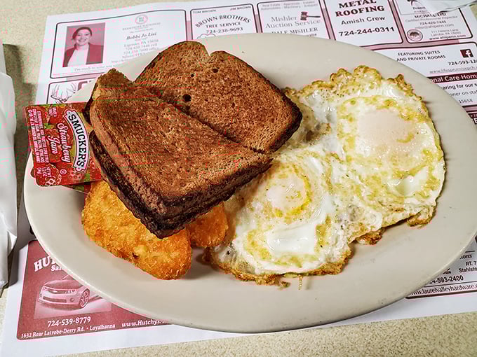 Breakfast perfection on a plate – where eggs, toast, and hash browns form the holy trinity of morning satisfaction.