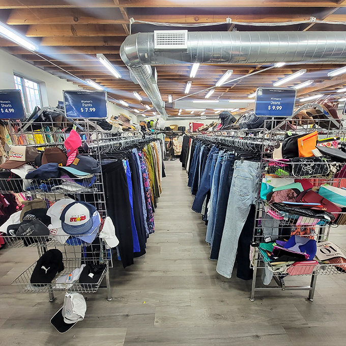 Rows of neatly arranged clothing await their second chance, organized by size and type—a rarity in the thrift store universe.