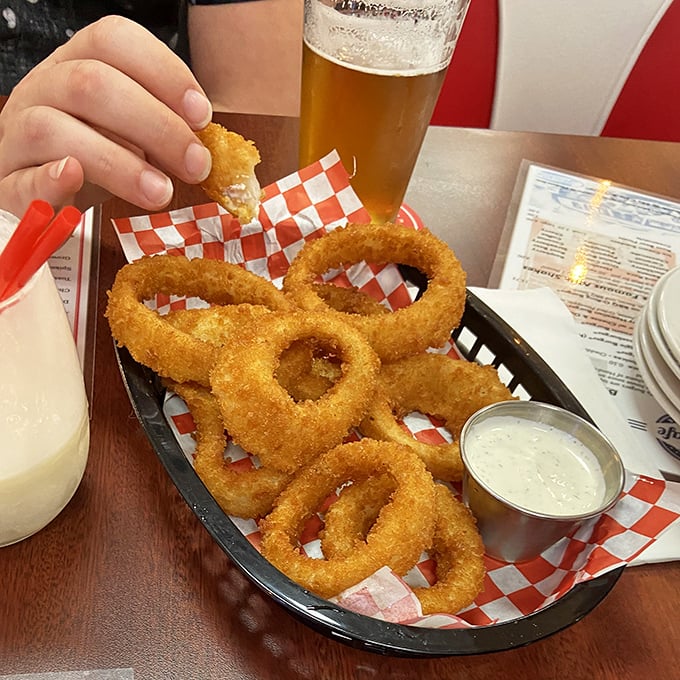 Golden halos of crispy perfection. These onion rings aren't just side dishes—they're edible jewelry that crunch like autumn leaves and taste like summer carnivals.
