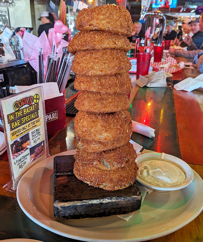 The leaning tower of onion rings—architectural marvel meets deep-fried perfection. Whoever said "less is more" clearly never experienced this golden-brown monument to excess.