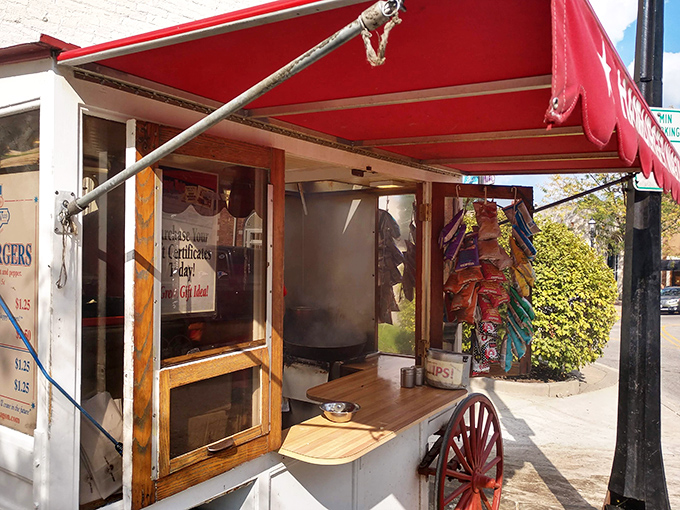 Peek inside the culinary time machine where burger magic happens. That red awning has sheltered more food dreams than a cooking channel marathon.