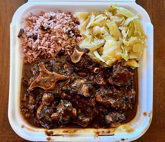 Oxtail stew that's been simmering toward perfection, creating a rich gravy that demands to be sopped up with every available carb in reach.
