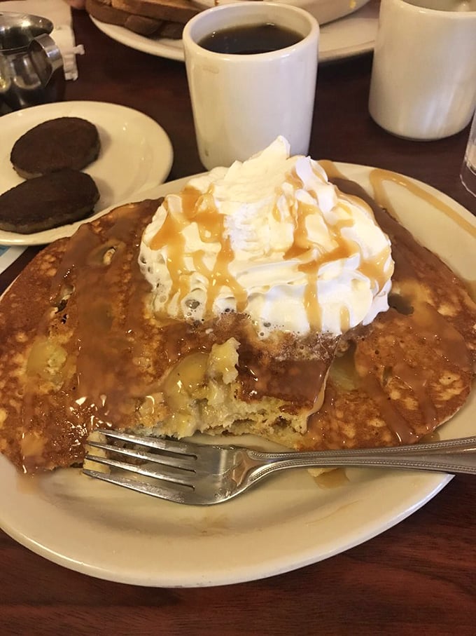 Pancake perfection with a crown of whipped cream and caramel drizzle. This isn't just breakfast—it's therapy on a plate.