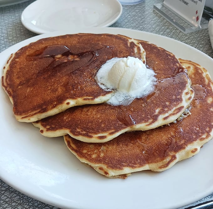 Pancakes so perfectly golden they belong in Fort Knox, topped with a scoop of butter melting like Atlanta in August.