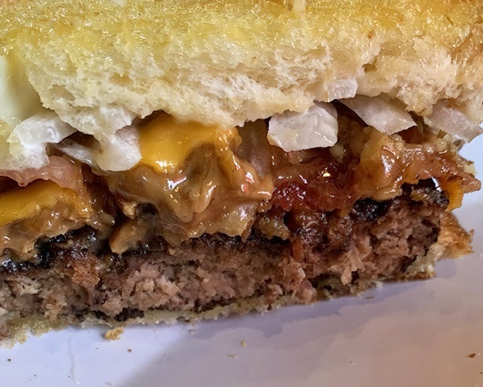 The cross-section reveals the truth—this isn't just a patty melt, it's a carefully orchestrated symphony of beef, cheese, and what appears to be peanut butter. Culinary courage at its finest.