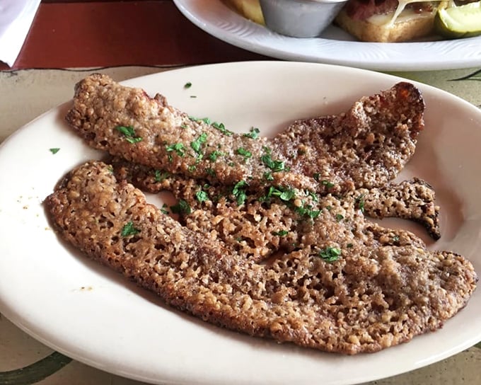 The legendary pecan-crusted bacon – where breakfast meat meets dessert in a romance that would make Shakespeare put down his quill and just eat.
