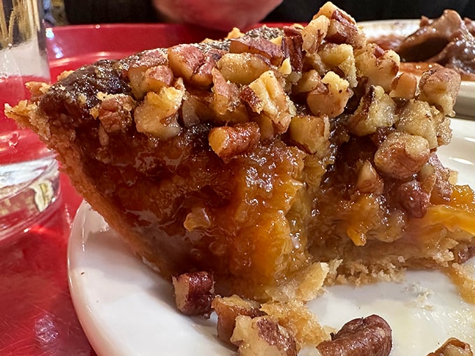 Pecan pie that doesn't mess around – a sweet, gooey center crowned with nuts that have clearly been arranged by someone who cares about your happiness.