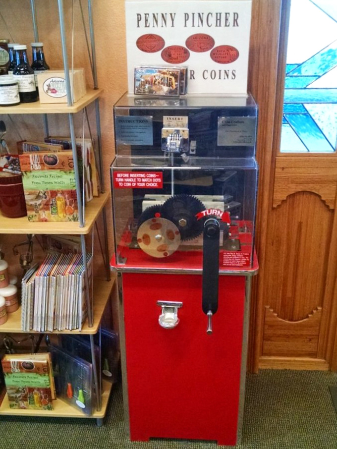 The Penny Pincher machine—where pocket change transforms into flattened souvenirs while your wallet breathes a sigh of relief.