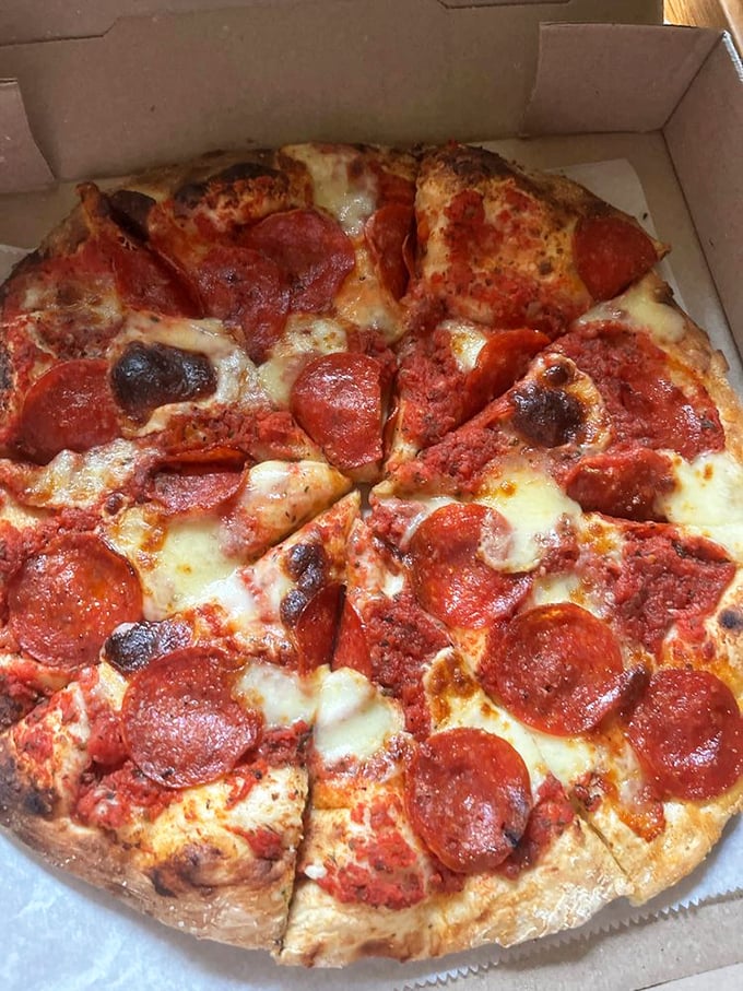 Pizza perfection from a brick oven that knows things—those charred pepperoni cups holding tiny pools of flavor are little miracles.