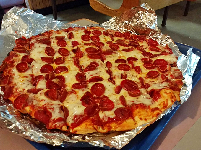 The pepperoni cups like tiny flavor reservoirs, each one collecting a precious pool of spiced oil. This isn't just food—it's edible engineering at its finest.