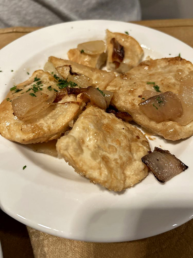These pierogies aren't just good, they're family-reunion-ending-in-happy-tears good. Golden-brown perfection topped with caramelized onions and ready for their close-up.