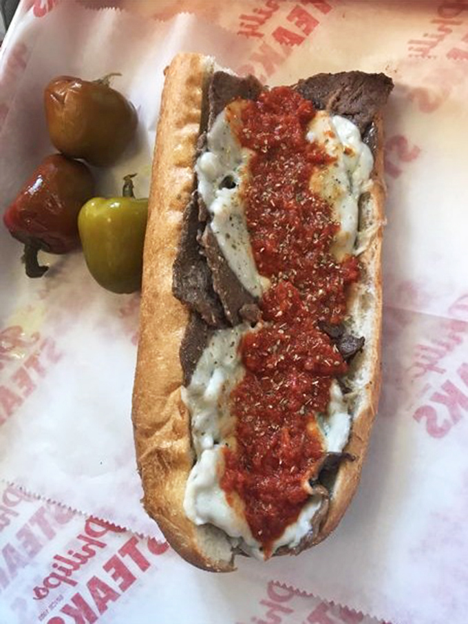 The pizza steak—where two Philly classics collide in holy matrimony. Those peppers on the side aren't just garnish; they're flavor grenades waiting to deploy.
