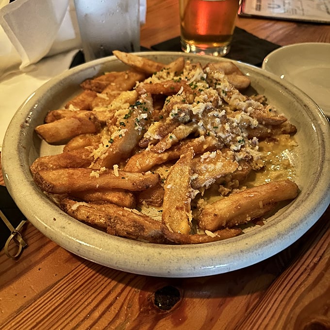These aren't your college dorm fries with sad packet cheese. This is potato royalty wearing a crown of savory goodness.