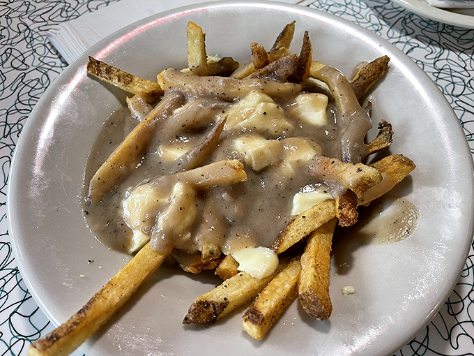 Gravy-drenched fries with melty cheese curds—proof that sometimes the messiest foods deliver the most direct route to happiness.
