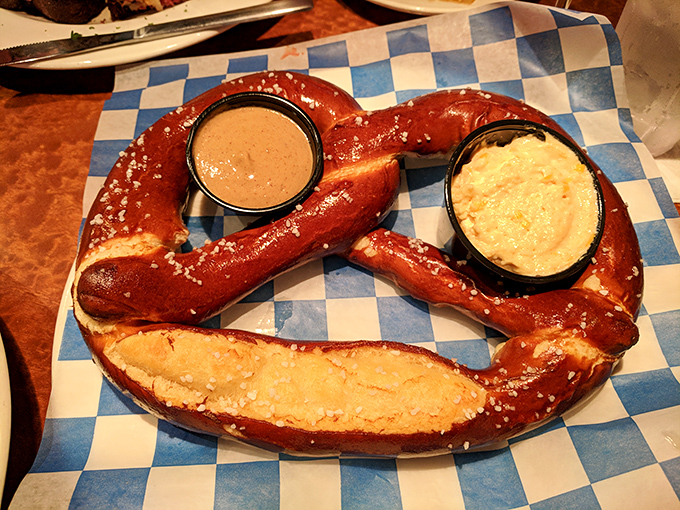 Not just any pretzel—this glistening, salt-flecked beauty with its dual dipping companions is what carb dreams are made of. Worth every delicious calorie.
