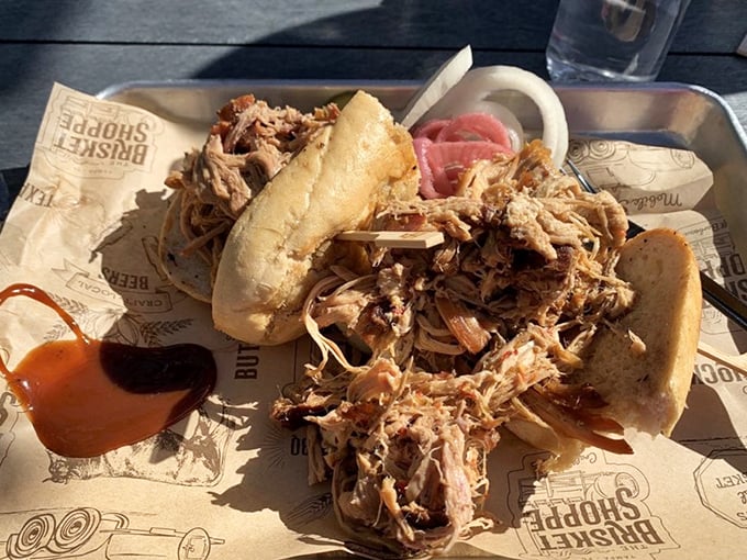 A pulled pork sandwich so generous it requires strategic planning – where to start, how to hold it, and whether to share (don't).
