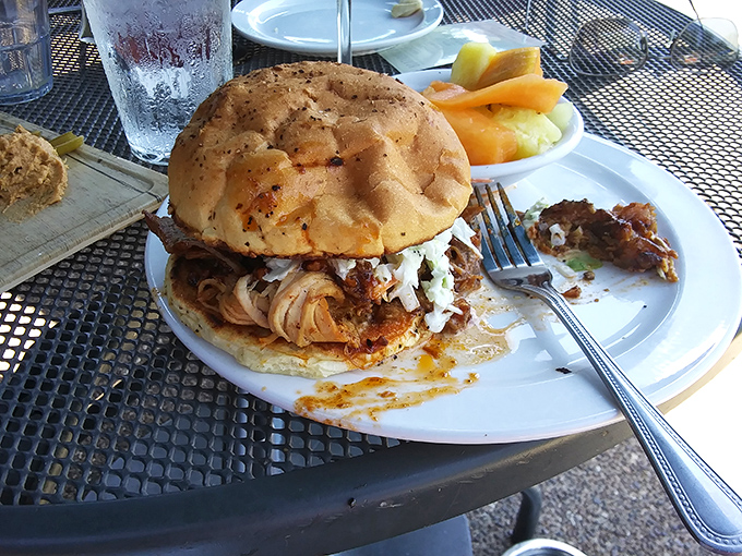 A sandwich that requires both hands and possibly a nap afterward – pulled pork piled high on a bun that somehow manages to hold it all together.