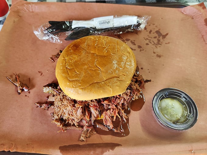 The pulled pork sandwich – a simple concept elevated to art form. That golden bun barely containing a mountain of smoky, tender pork goodness.
