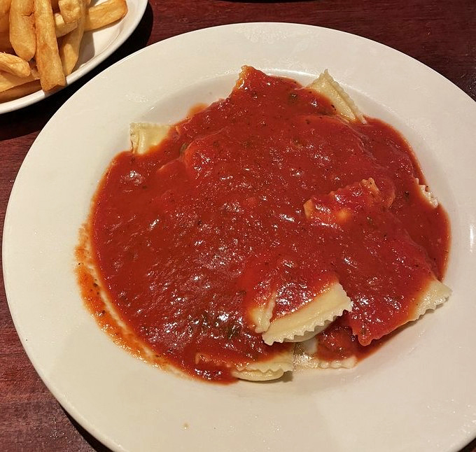 Ravioli swimming in a sea of rich tomato sauce—proof that sometimes the simplest pleasures are the ones that stick with you long after dinner's over.