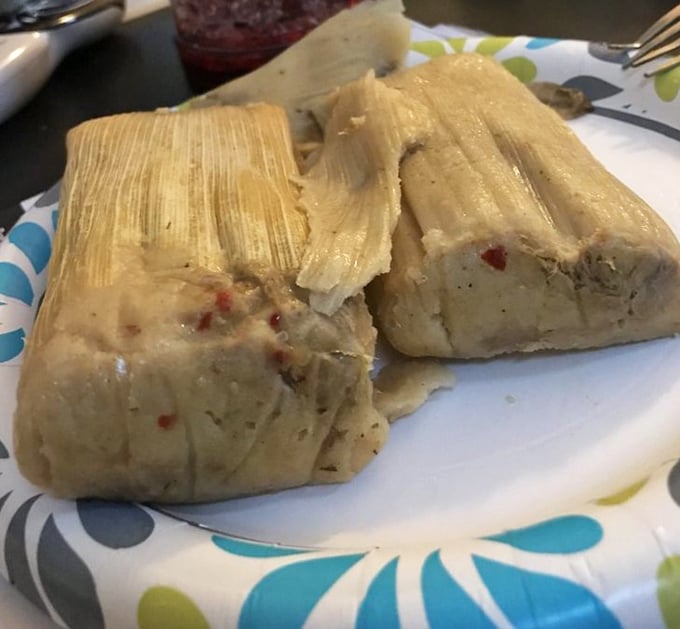 Two tamales, side by side, like old friends sharing secrets of corn masa, spices, and generations of culinary wisdom.