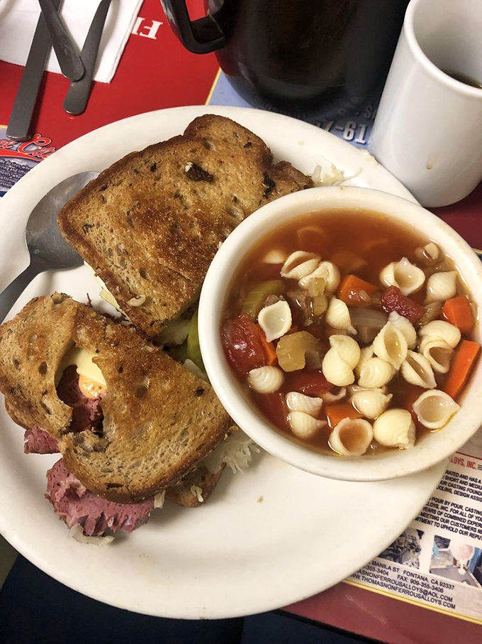 This isn't just a sandwich – it's a proper Reuben with a side of homemade soup that makes you wonder why you'd ever eat anywhere else.