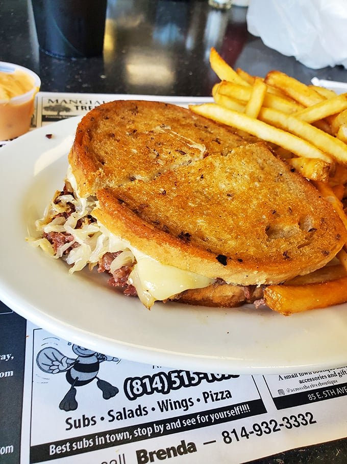 The Reuben sandwich – a masterpiece of corned beef, sauerkraut, and melted Swiss that demands both hands and several napkins.