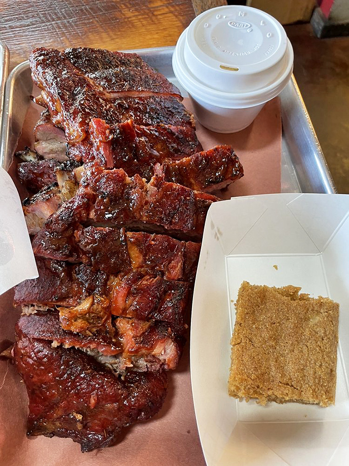 Ribs that would make Fred Flintstone weep with joy – the perfect marriage of smoke, spice, and that magical moment when meat surrenders to time.