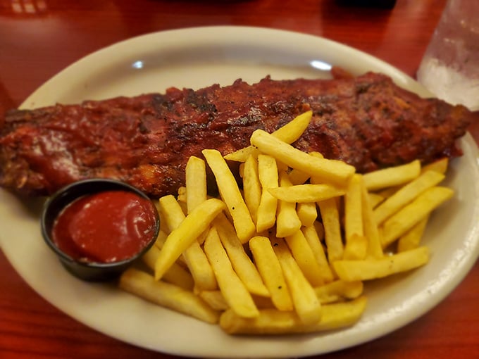These ribs aren't falling off the bone—they're voluntarily leaping into flavor paradise with golden fries as their sidekick.
