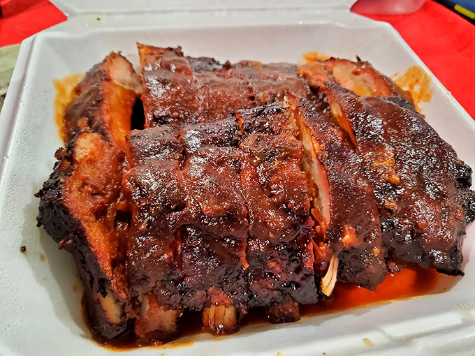 Ribs glistening with sauce and sporting that telltale smoke ring—the kind that make you temporarily forget table manners exist.