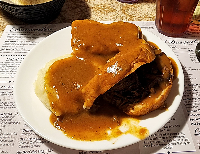 The hot roast beef sandwich arrives like a savory island in a sea of gravy—the kind of meal that makes you want to hug the chef.