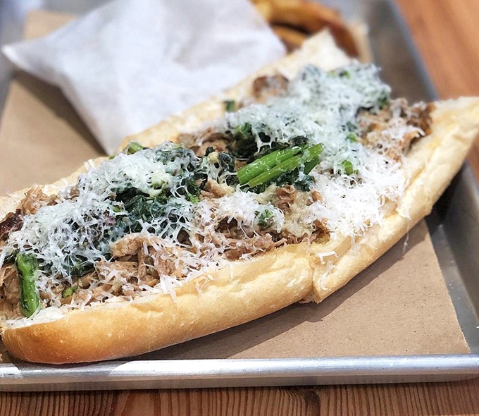 Roast pork, sharp greens, and a shower of parmesan—this sandwich doesn't need to shout to make its delicious point.