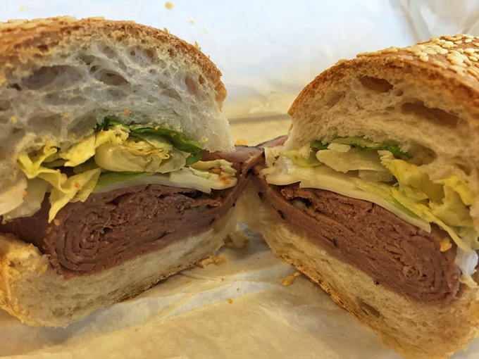 Behold the star of the show—roast beef sliced so thin it practically dissolves on contact, nestled in crusty bread with fresh veggies.