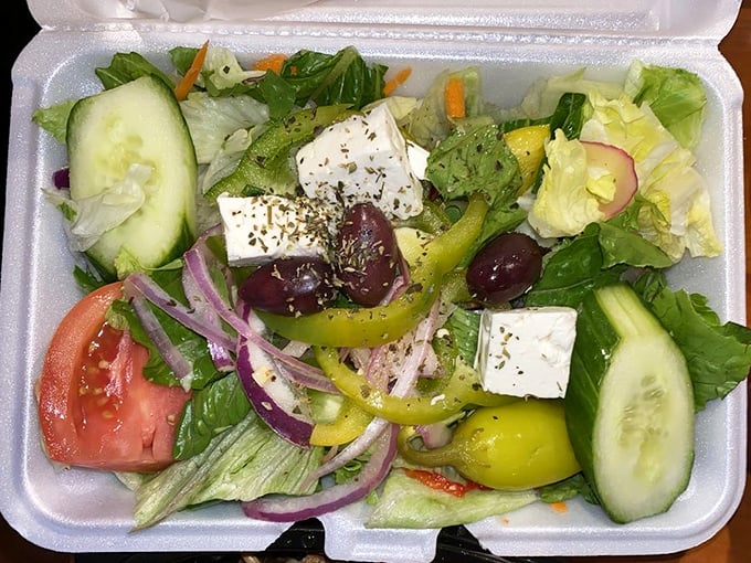 A Greek salad that respects the classics—crisp vegetables, briny olives, and feta cheese that hasn't forgotten its Mediterranean roots.