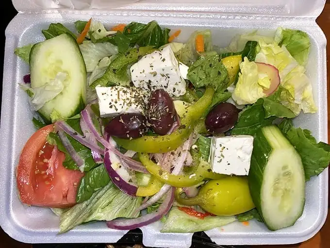 A Greek salad that respects the classics—crisp vegetables, briny olives, and feta cheese that hasn't forgotten its Mediterranean roots.