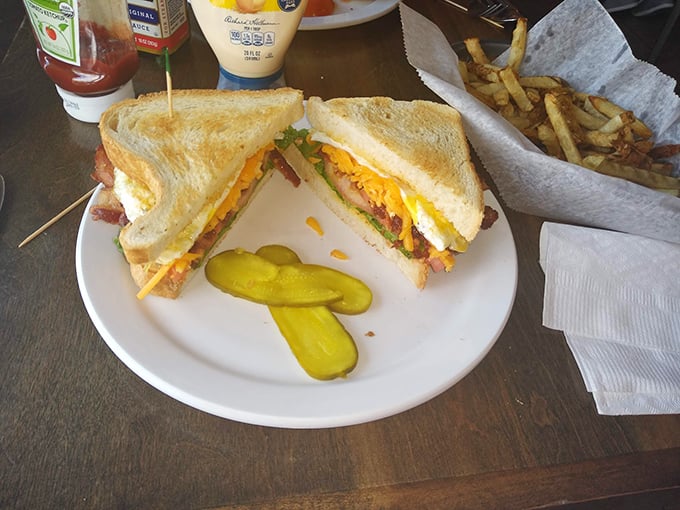 A sandwich that requires strategic planning to eat—notice the pickle spears standing by like tasty lifeguards ready to refresh your palate.