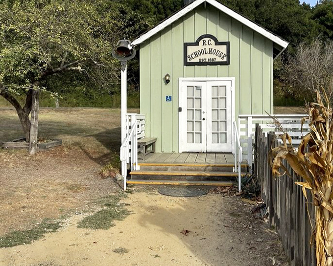 The charming mint-green schoolhouse stands as a reminder that even frontier communities valued education—though I doubt they taught "locomotive appreciation."