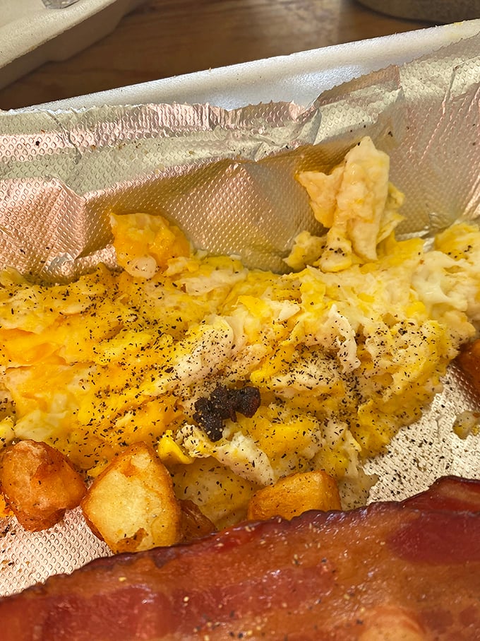 Scrambled eggs nestled in foil like precious cargo, because sometimes the simplest things deserve the fanciest treatment.