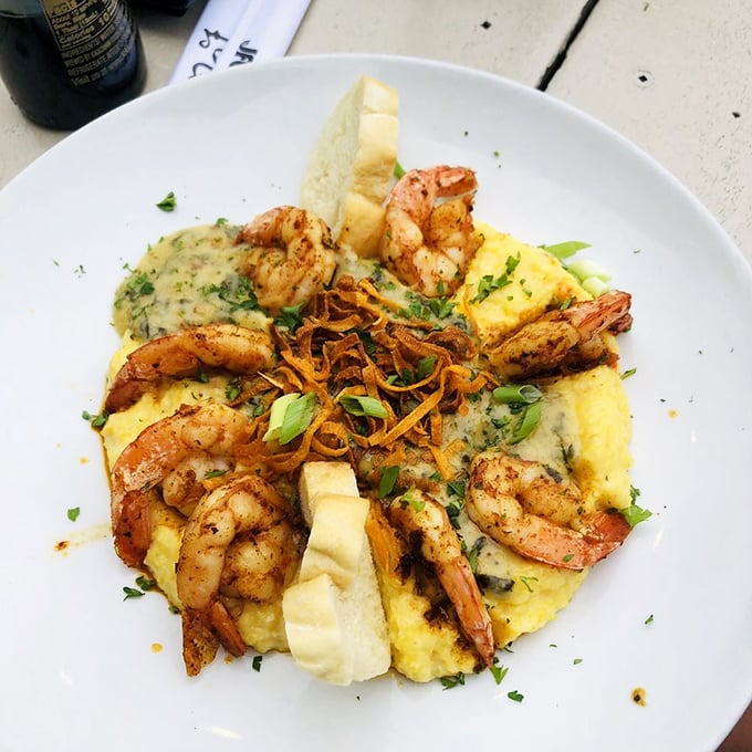The Grits a Ya Ya in all its glory – plump Gulf shrimp nestled on a cloud of smoked Gouda grits. This isn't just dinner; it's edible Southern poetry.