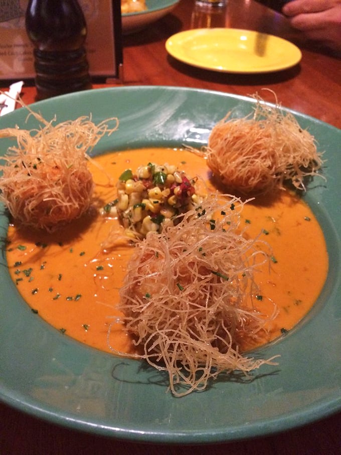 These aren't your average fritters – they're crispy orbs of seafood joy swimming in a sauce that deserves its own area code.