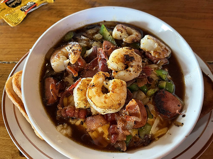 Low country meets high flavor! Plump shrimp swimming in savory broth alongside vegetables and sausage—proof that brunch can be an adventure.