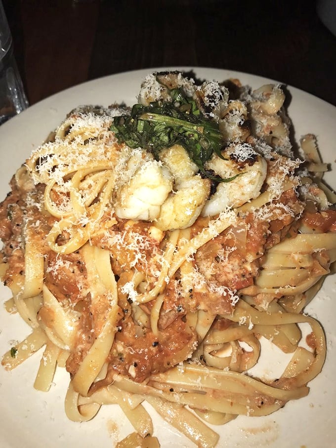 Pasta that doesn't just sit on the plate but performs—tender fettuccine embracing a robust sauce with seafood that clearly didn't hit the snooze button.