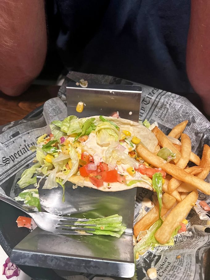 A taco that doesn't just sit on your plate—it performs. Fresh lettuce, bright tomatoes, and a tortilla that knows its supporting role perfectly.