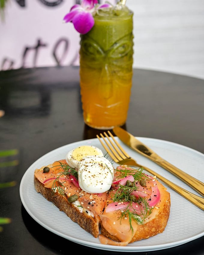 Smoked salmon toast that would make a New York deli nod in respect – those perfectly poached eggs perched atop like little clouds of breakfast heaven.