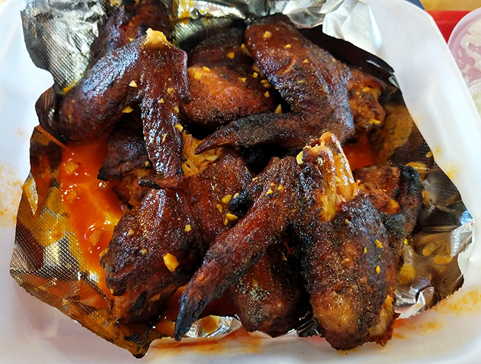 Wings that look like they've earned PhDs in smokology—crispy, glistening, and unapologetically sauced in what can only be described as liquid happiness.