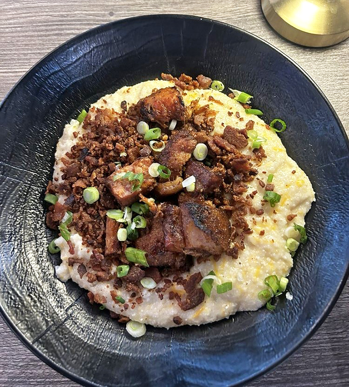 Grits transformed from Southern staple to canvas for pork perfection. Those green onions aren't garnish—they're the world's tiniest "I'm being healthy" alibi.